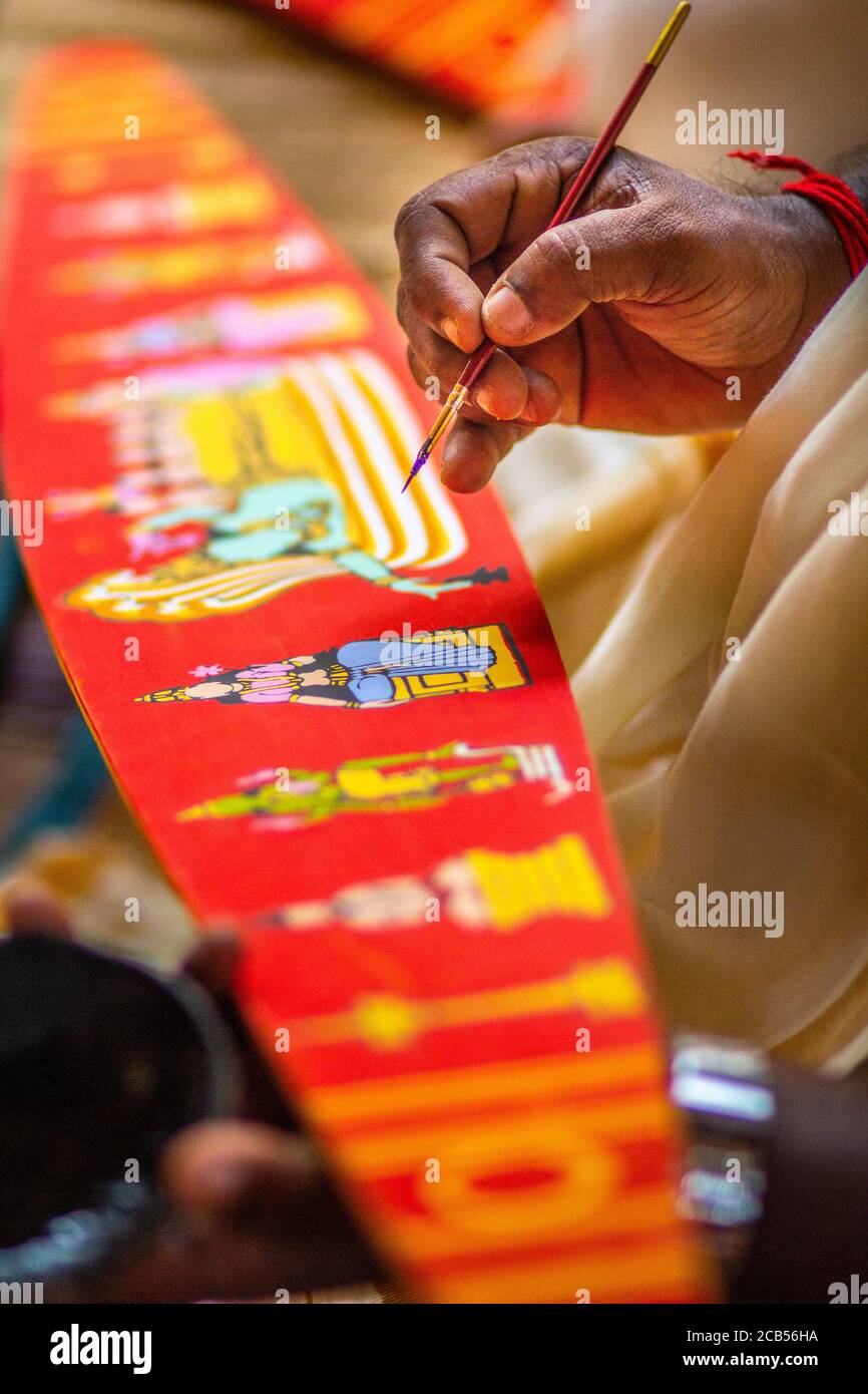 The Ceremonial bow, Onavillu. Artisan painting god's pictures on bow ...