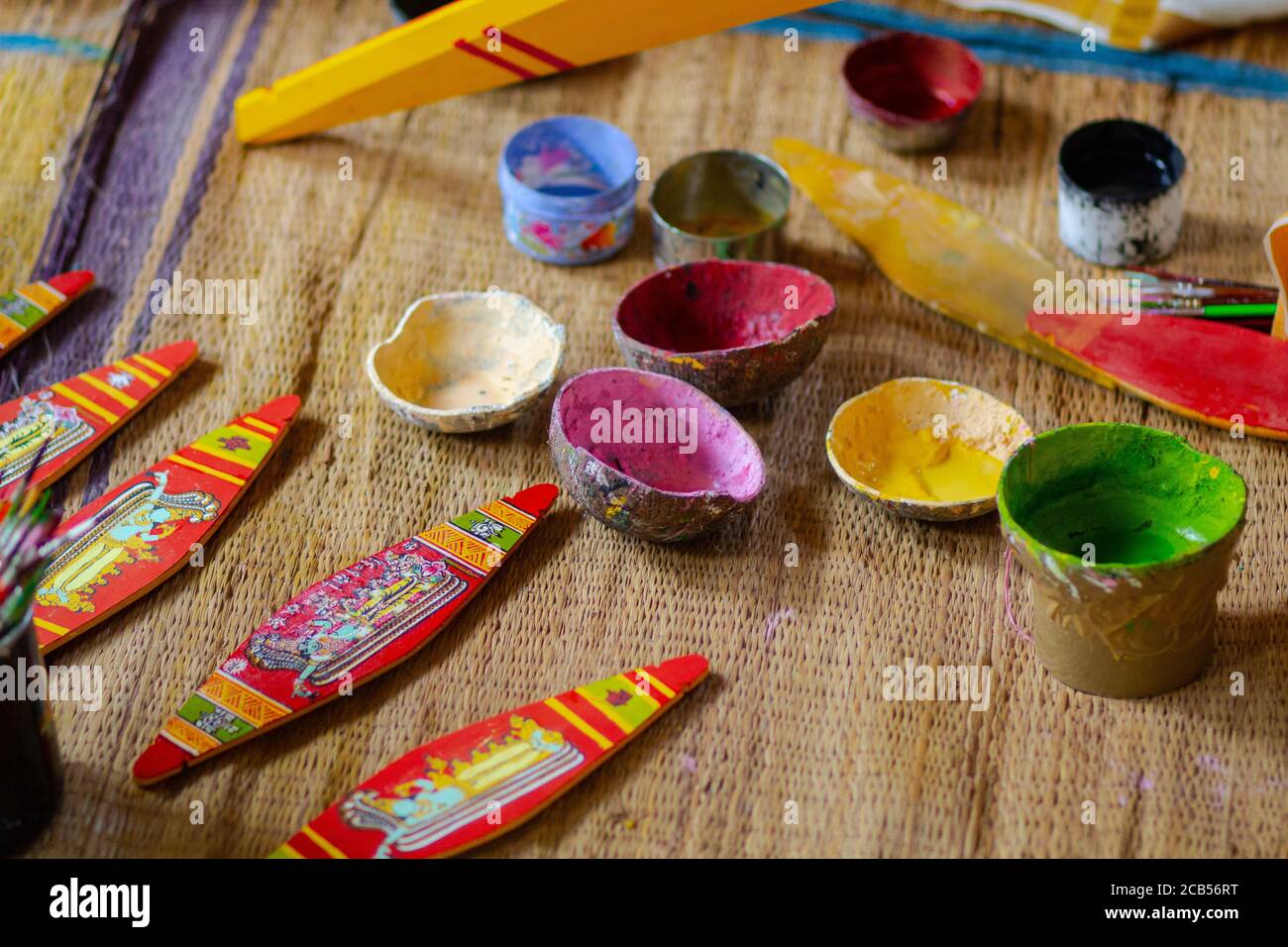 The Ceremonial bow, Onavillu. Artisan painting god's pictures on bow ...