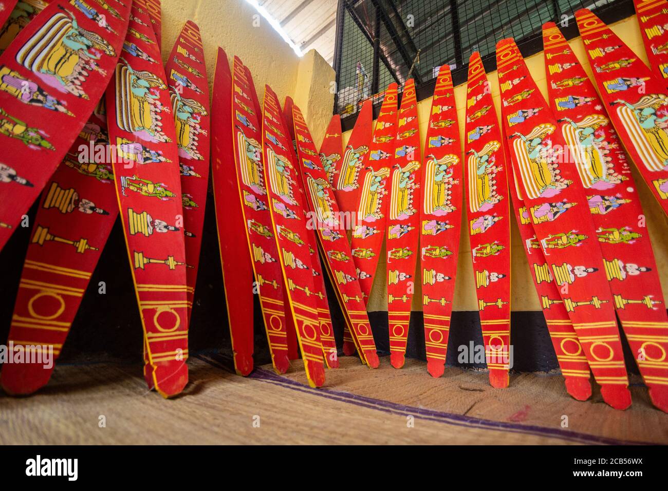 The Ceremonial bow, Onavillu. Artisan painting god's pictures on bow ...