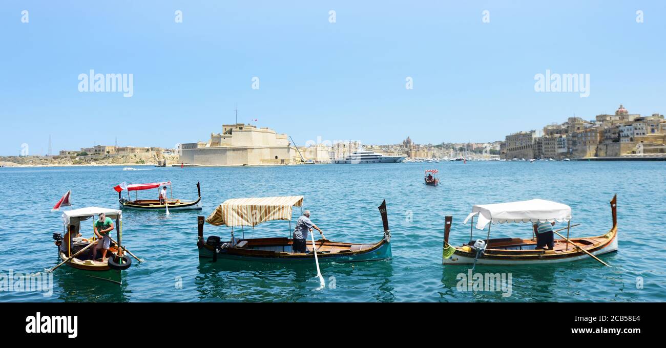 Traditional Maltese water taxi in the Grand Harbour in Valletta, Malta ...