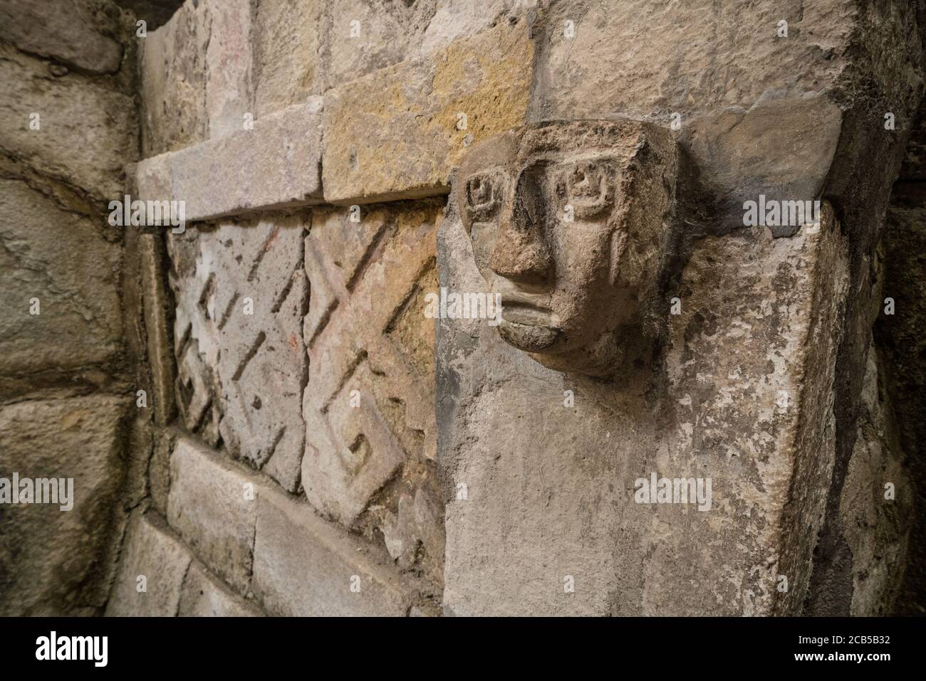 Detail of the carved heads and geometric designs flanking the entrance ...