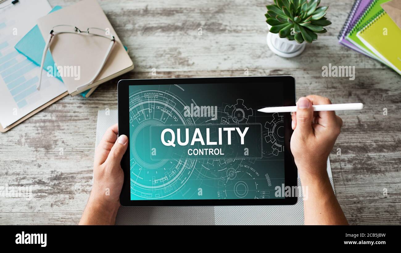 Quality control concept on device screen. Business and technology ...
