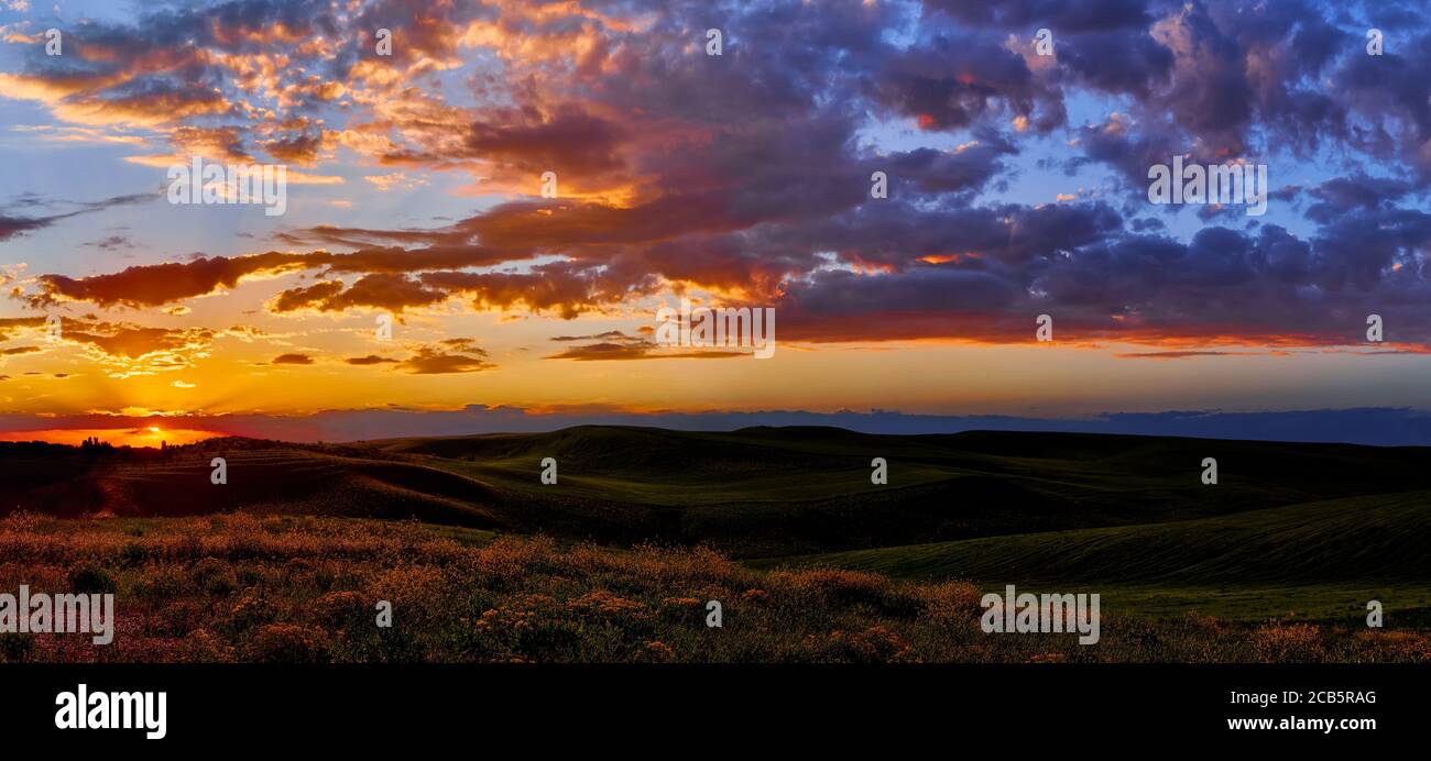 Mountain valley panorama in summer, cloudy sky. A fabulous sunset over ...