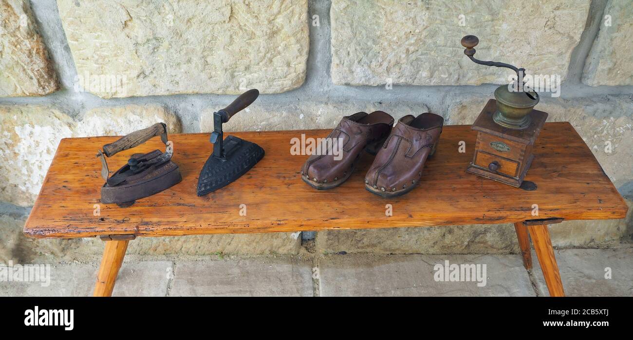wo old rusty antique iron with wooden handle, hand coffee grinder and ...