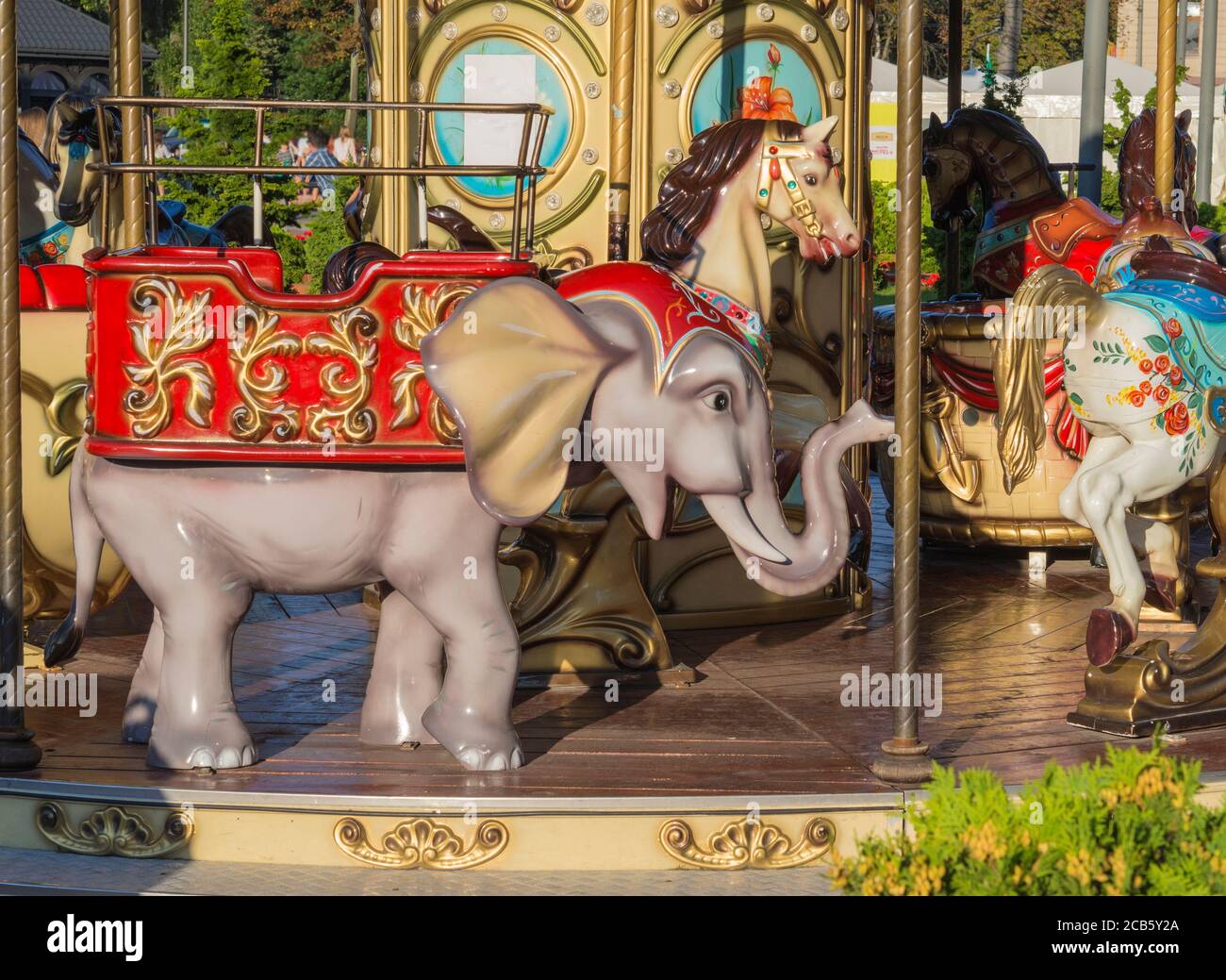 old carousel colorful elephant in golden evening light Stock Photo - Alamy