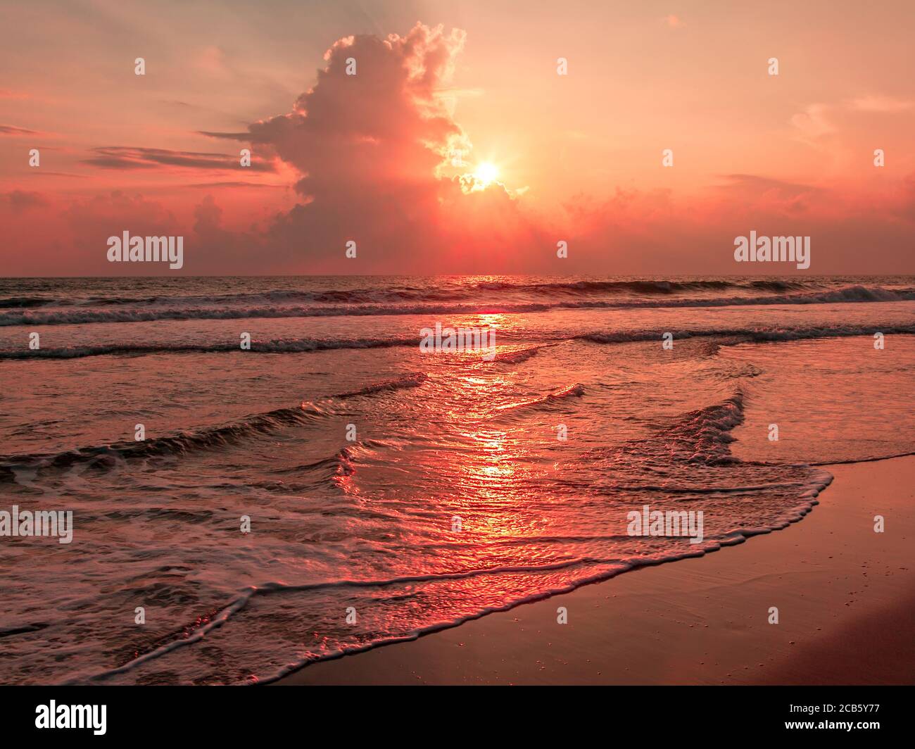 Spectacular lines of waves on the seashore in the rays of the rising ...