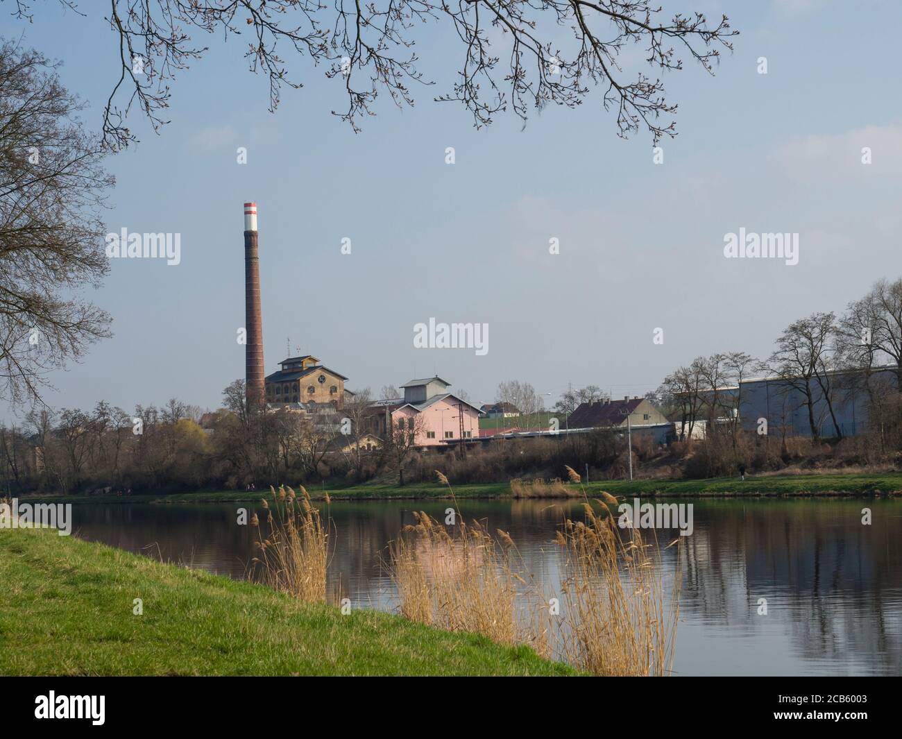 old historical factory building with chimney across the river elbe ...