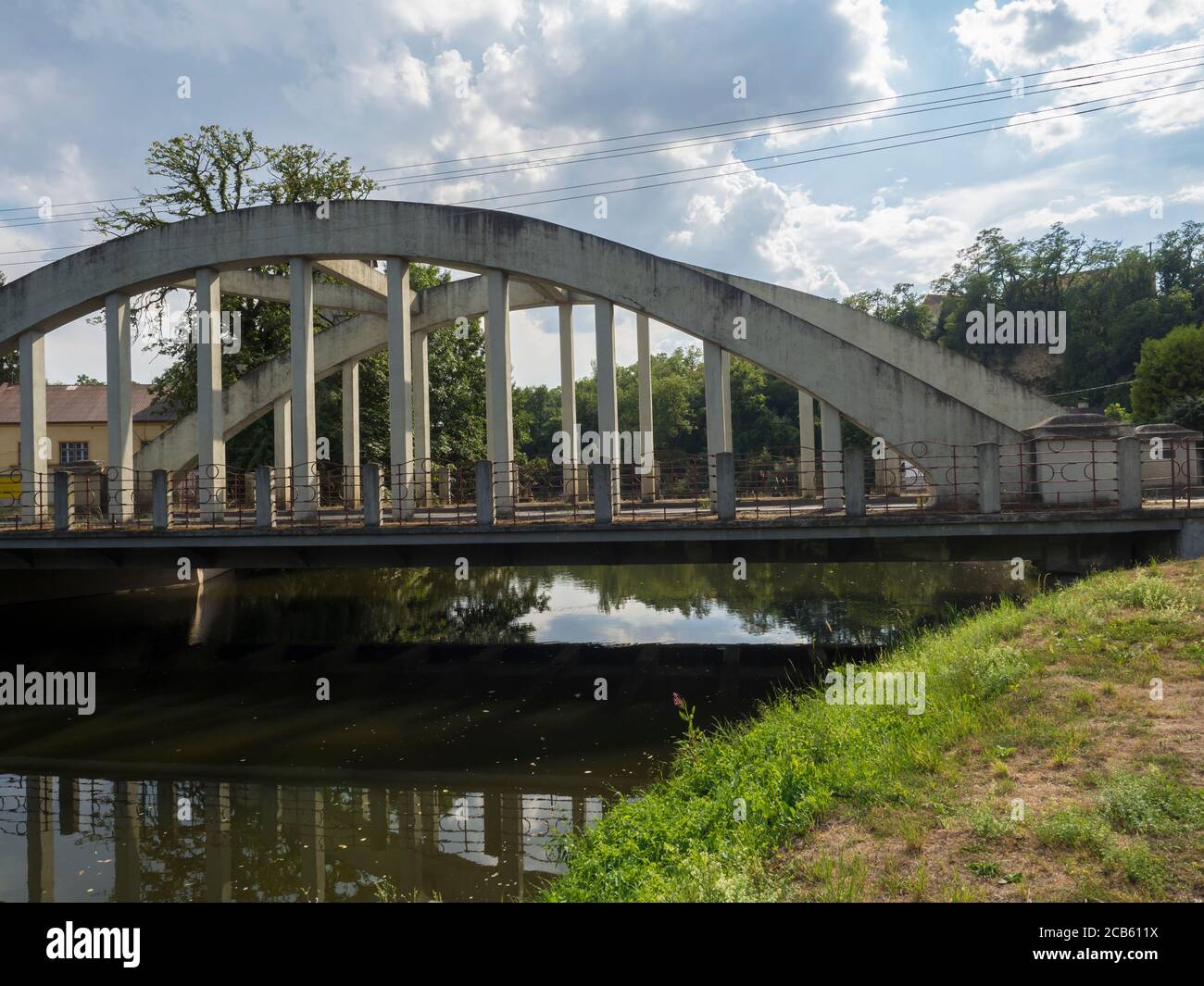 old arc bridge across Jizera river made concrete and metal with view on ...