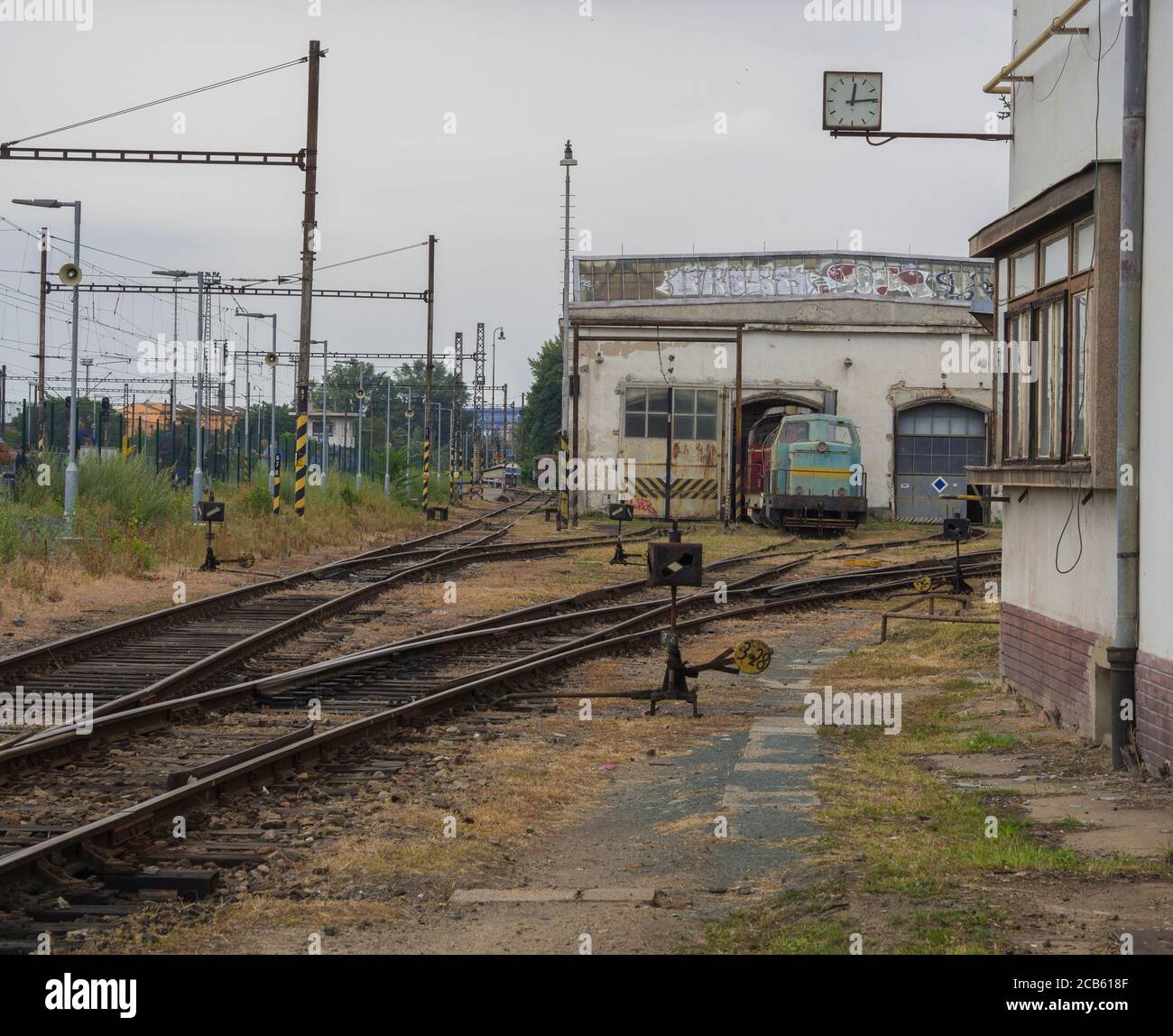 Old rusty railway station with train depot and rail trackstrain hi-res ...