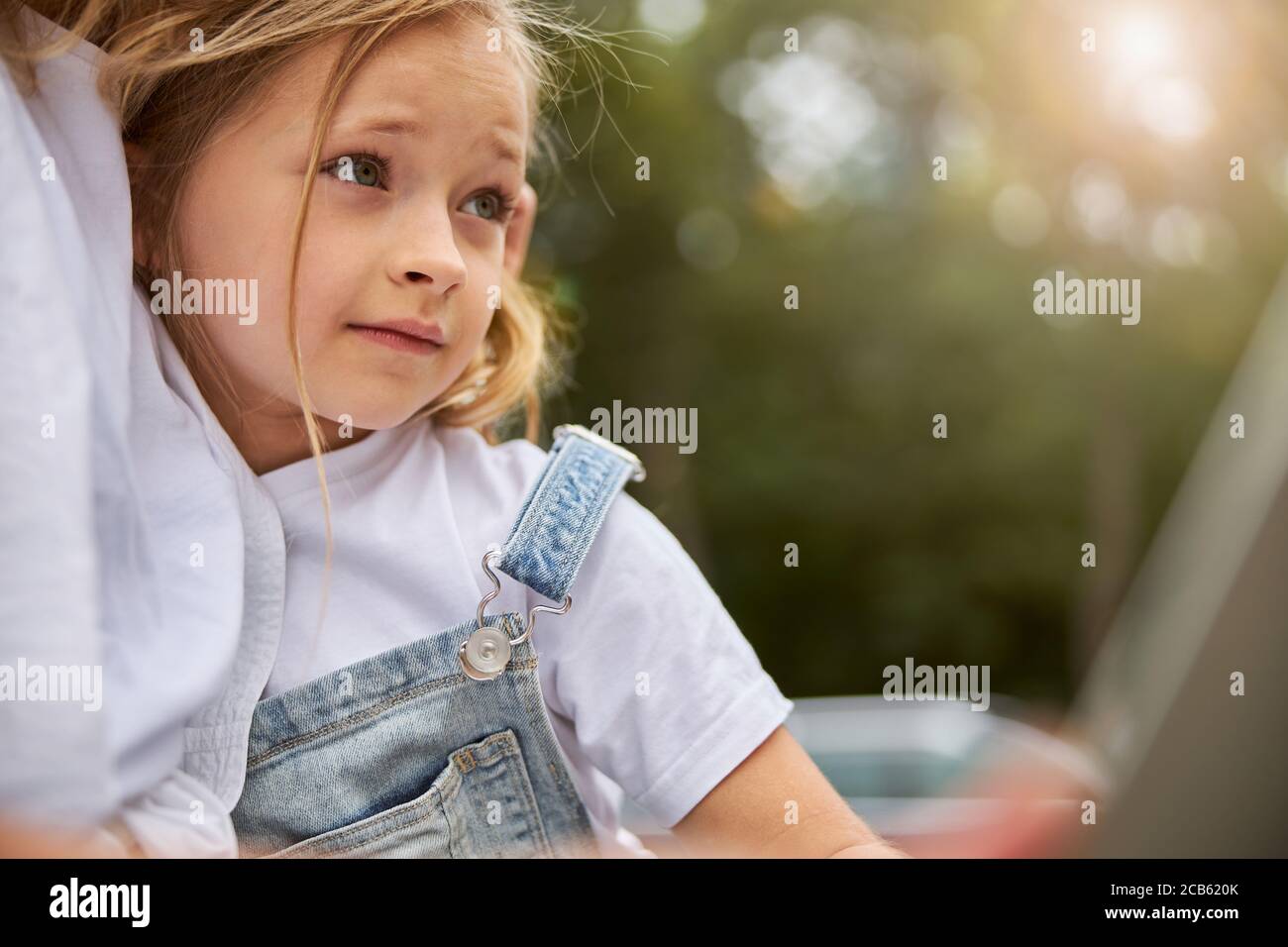 Good young girl sitting near the woman Stock Photo - Alamy