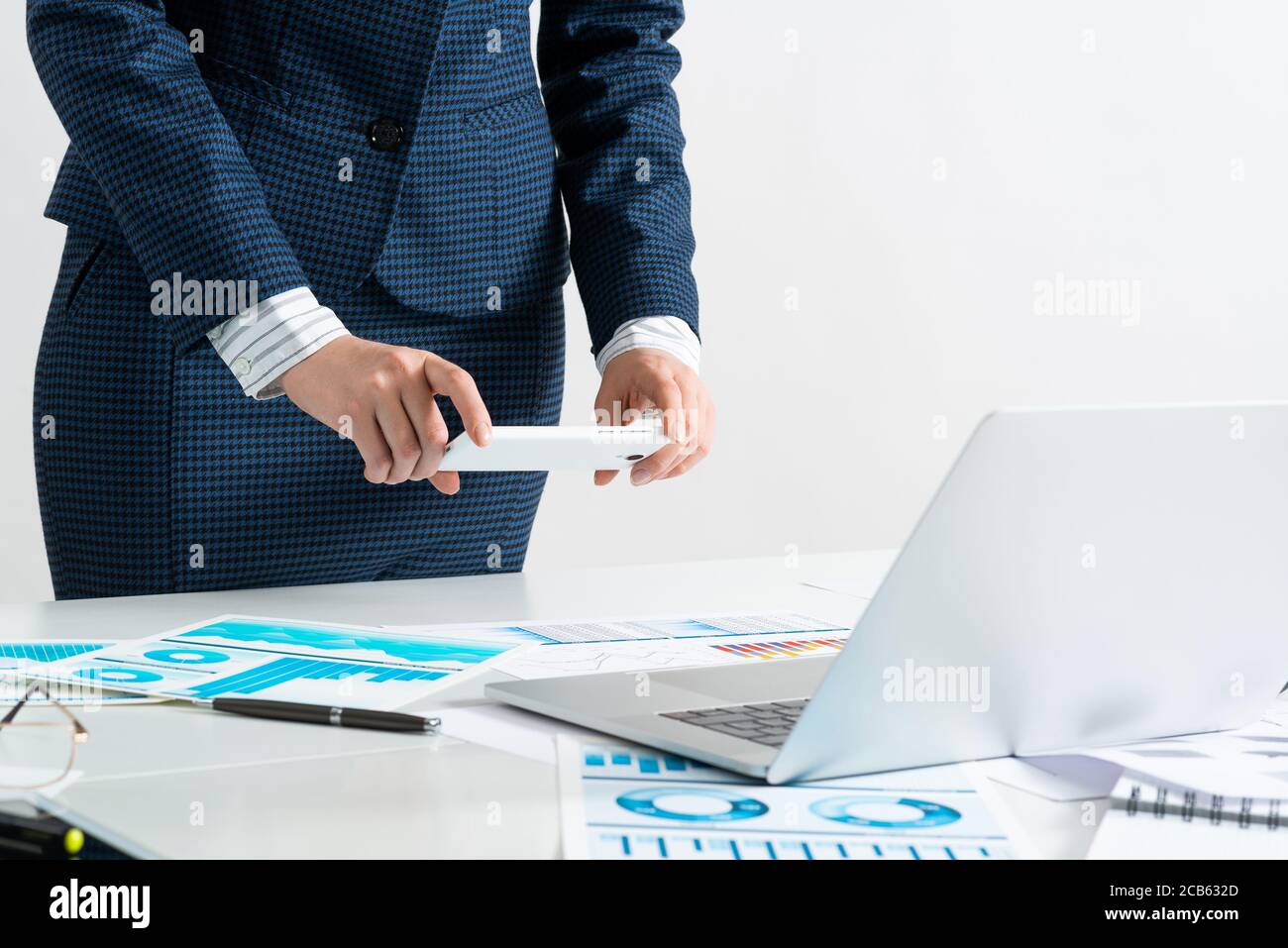 Businesswoman doing photo of document Stock Photo - Alamy