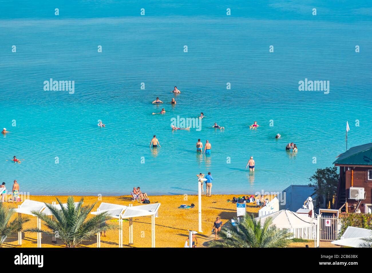 Tourists float in the heavy waters of the Dead Sea, Israel Stock Photo ...