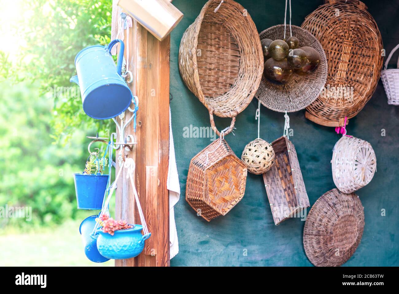 Second-hand blue saucepans, small bucket , jug and old straw baskets ...