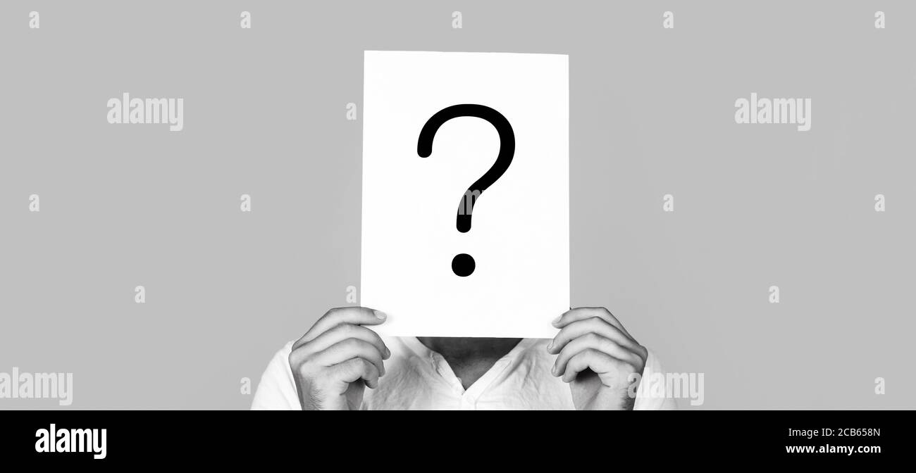 Man a question. Doubtful man holding Question Mark. Question mark ...