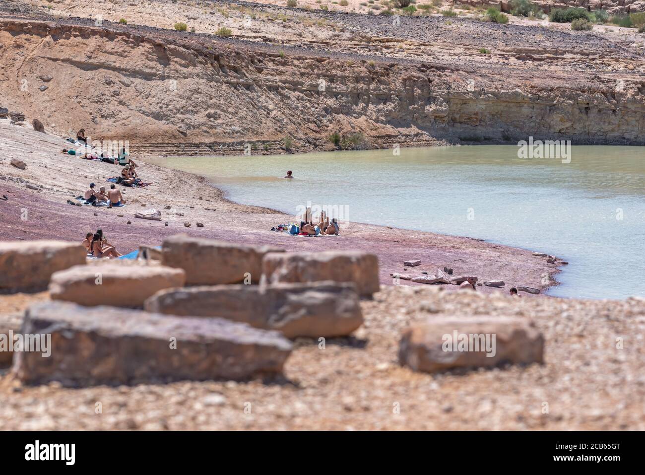 Hikers swim at a natural water hole off the beaten track in the Negev ...