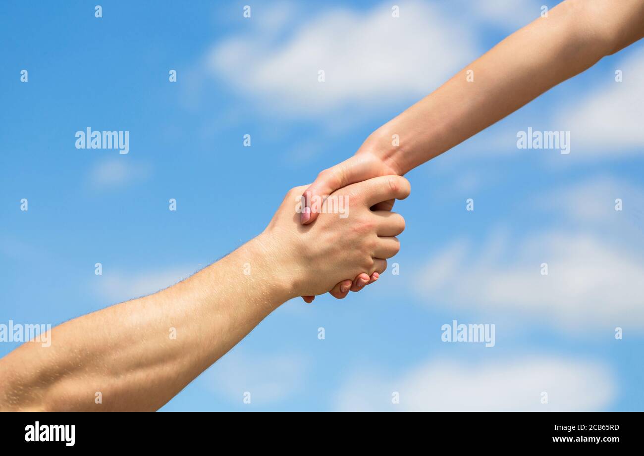 Hands of man and woman reaching to each other, support. Giving a ...