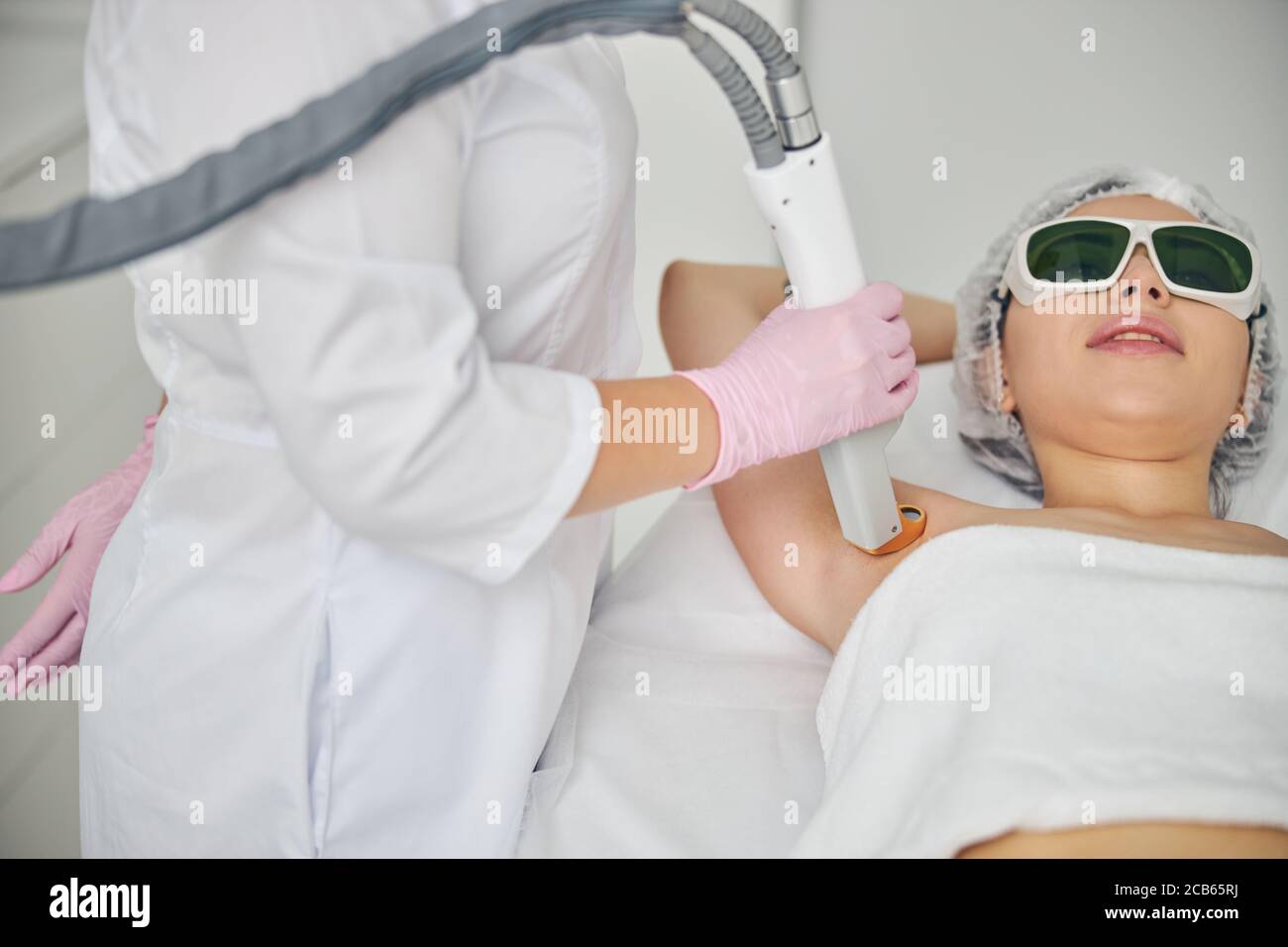 Doctor directing the laser beam on the patient underarm area Stock ...