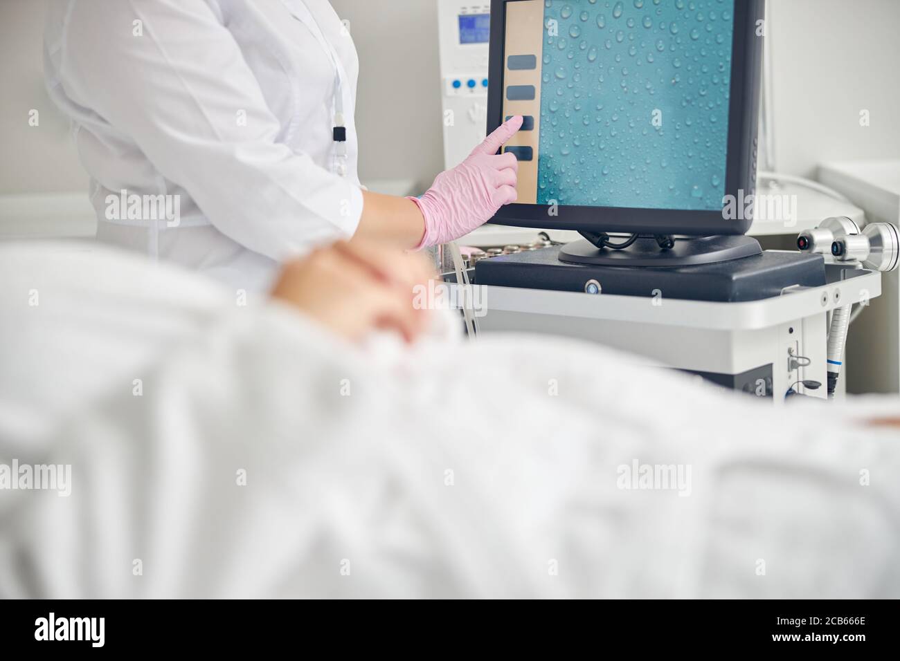 Woman hands touching the screen of a beauty machine Stock Photo - Alamy