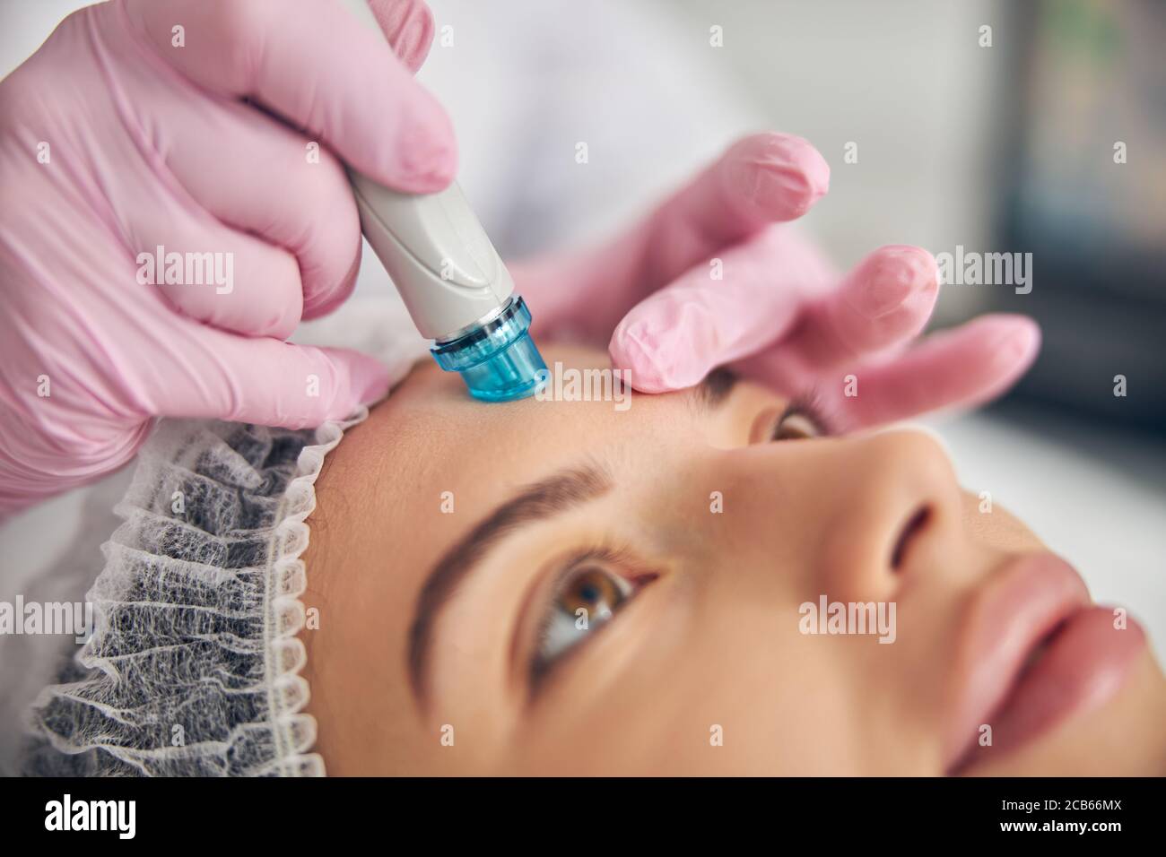 Professional woman cosmetician performing hi-res stock photography and ...