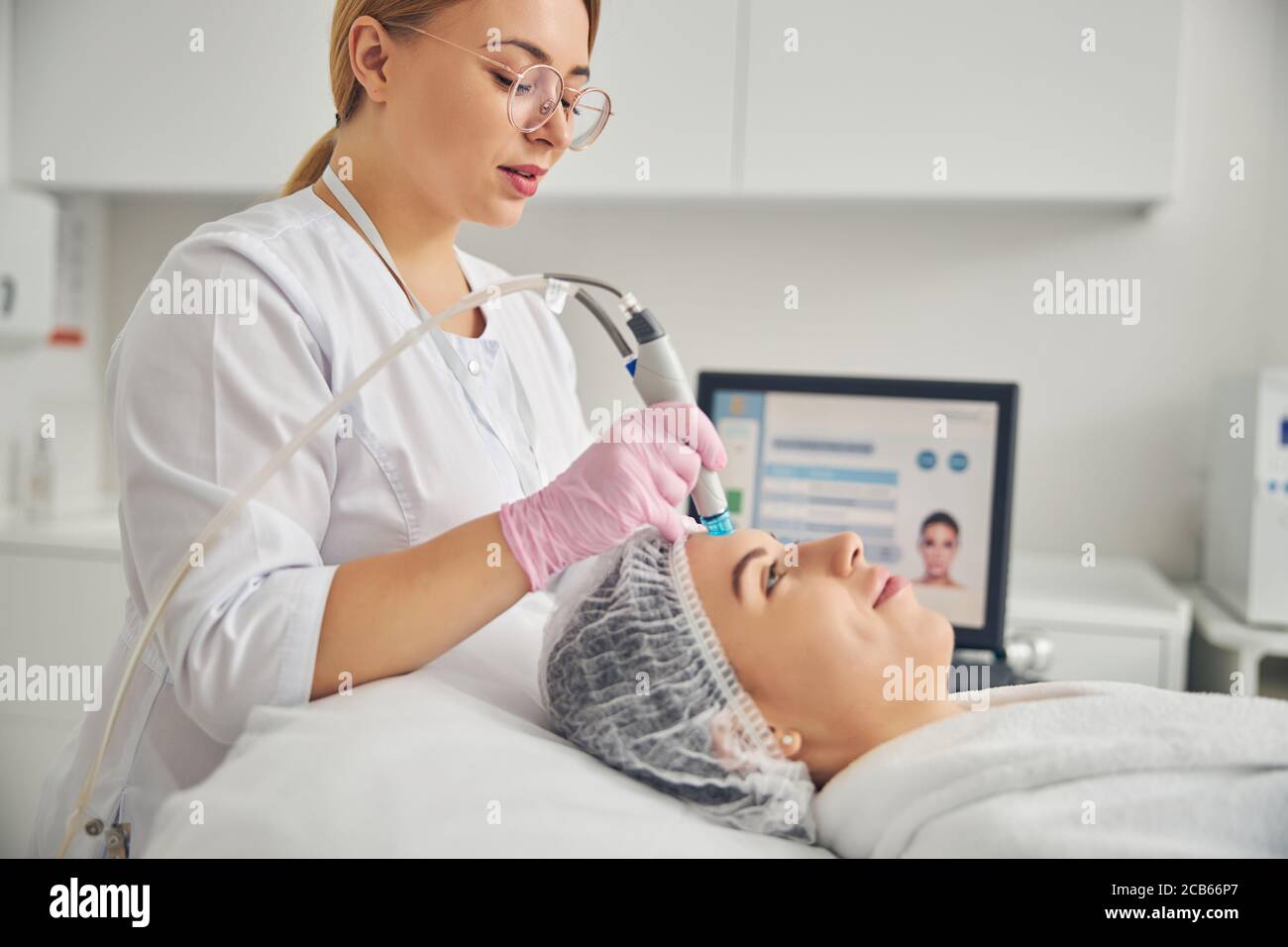 Woman being treated by a professional dermatologist Stock Photo - Alamy