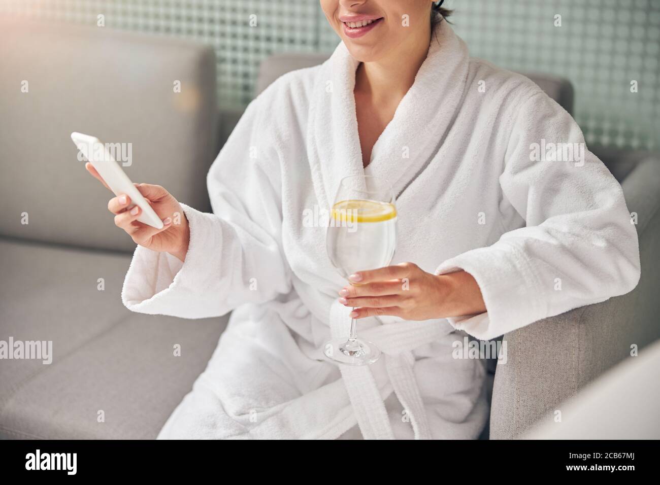 Pleased spa client sitting on the sofa Stock Photo - Alamy