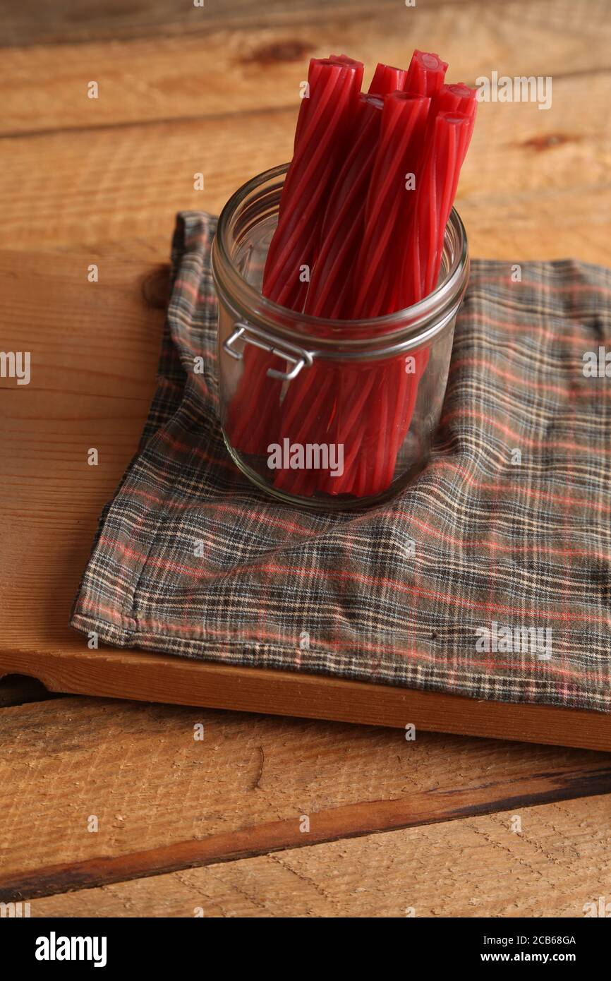 Vertical shot of red candy sticks in a jar on a wooden board Stock ...