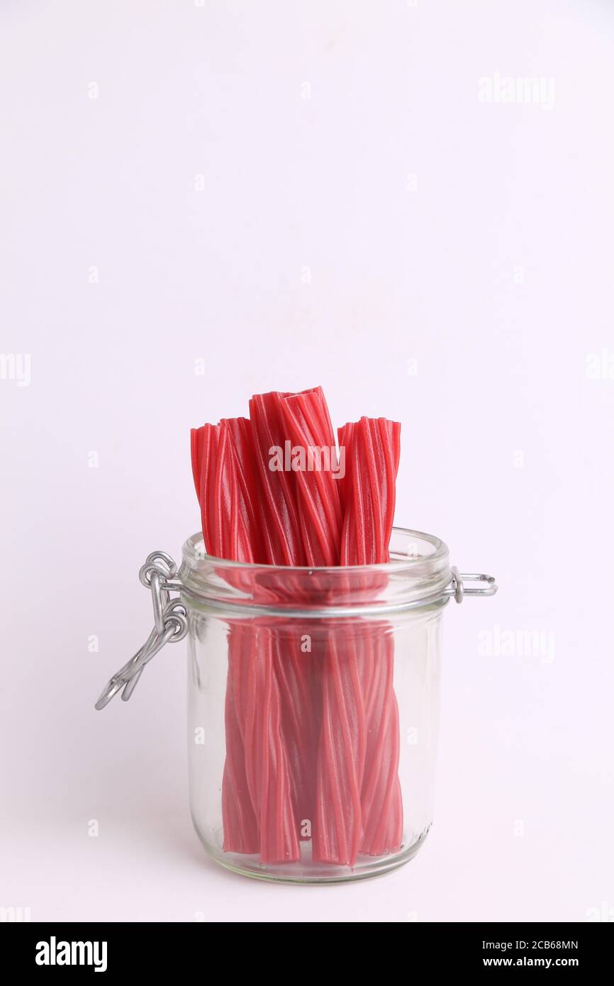 Sweet red candy sticks in the glass jar on the white background Stock ...