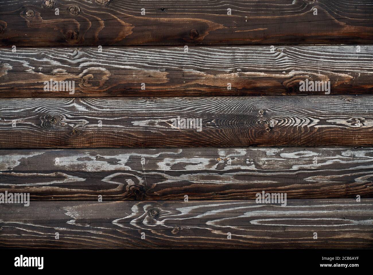 Brown aged volume rough rustic pallets on house wall outdoors, dark ...