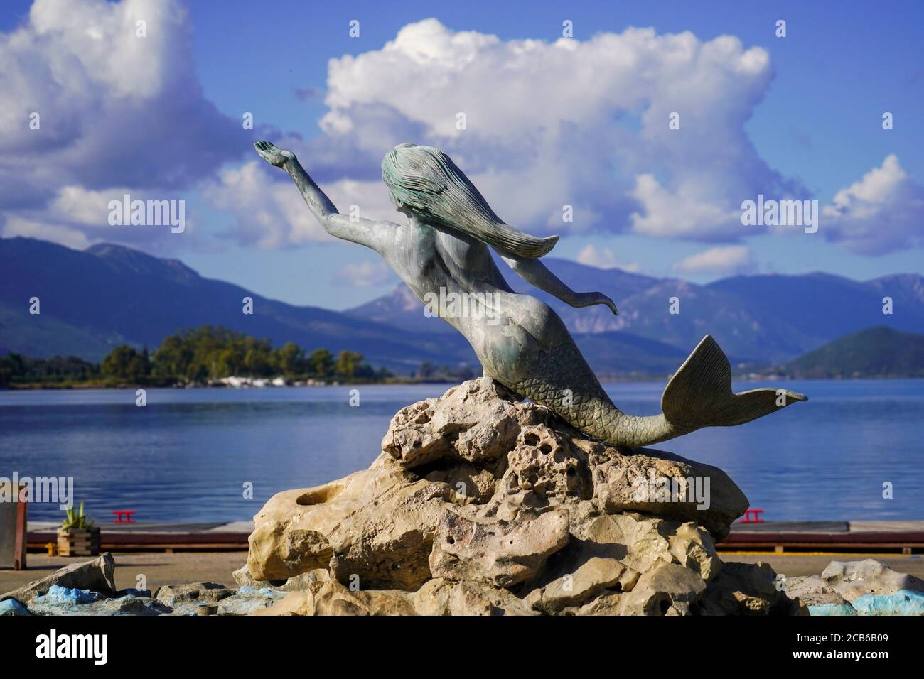 Mermaid statue and water fountain on the waterfront of Poros Town ...