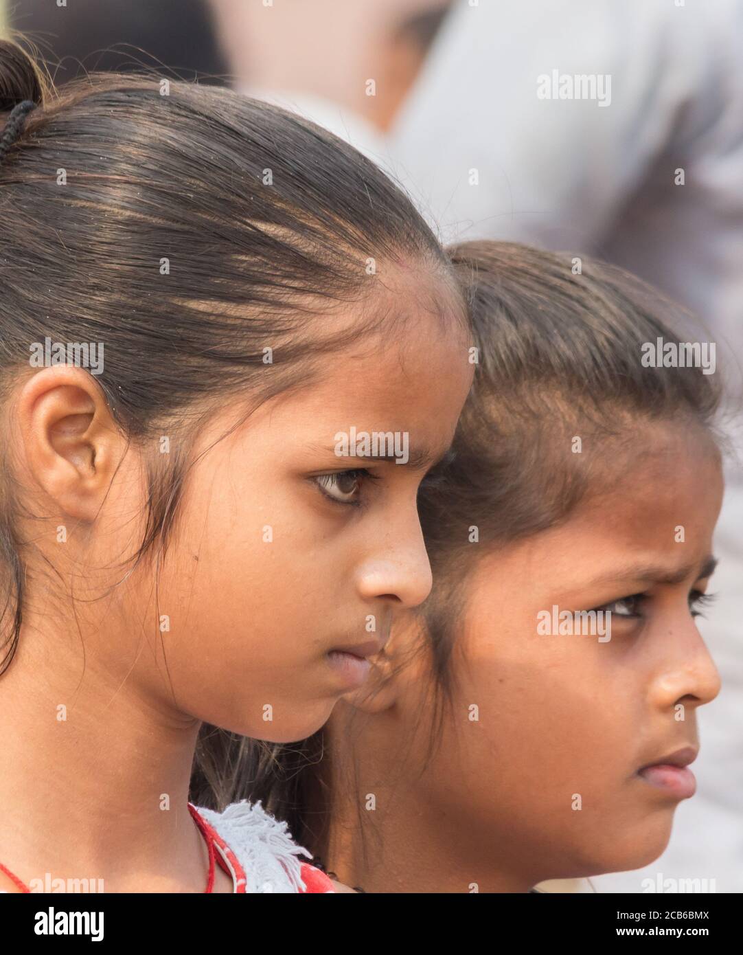 Portrait of two serious looking young indian girls at the Jama Masjid ...