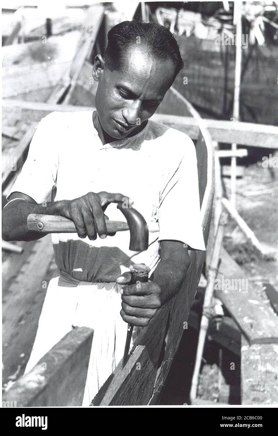 Shipwright uses chisel to notch boat plank, Calcutta 1944 Stock Photo ...