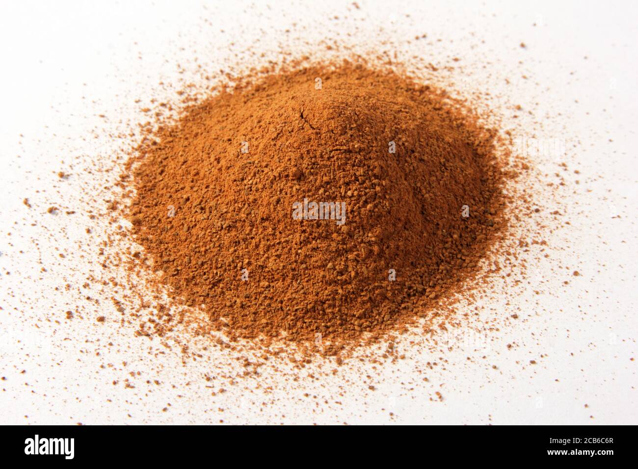 Cinnamon powder heap isolated on white background Stock Photo - Alamy