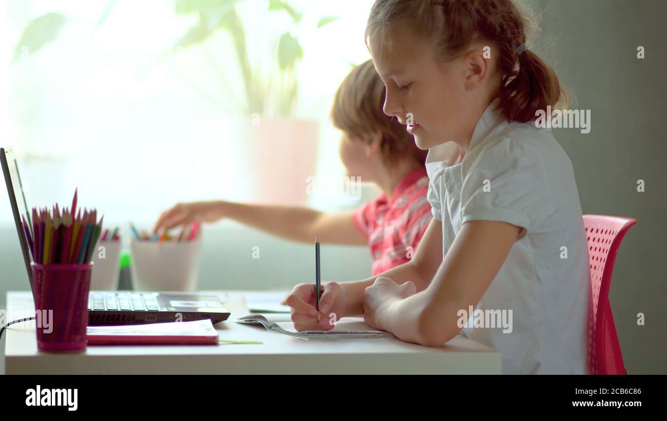 Cute children use laptop for education, online study, home studying ...