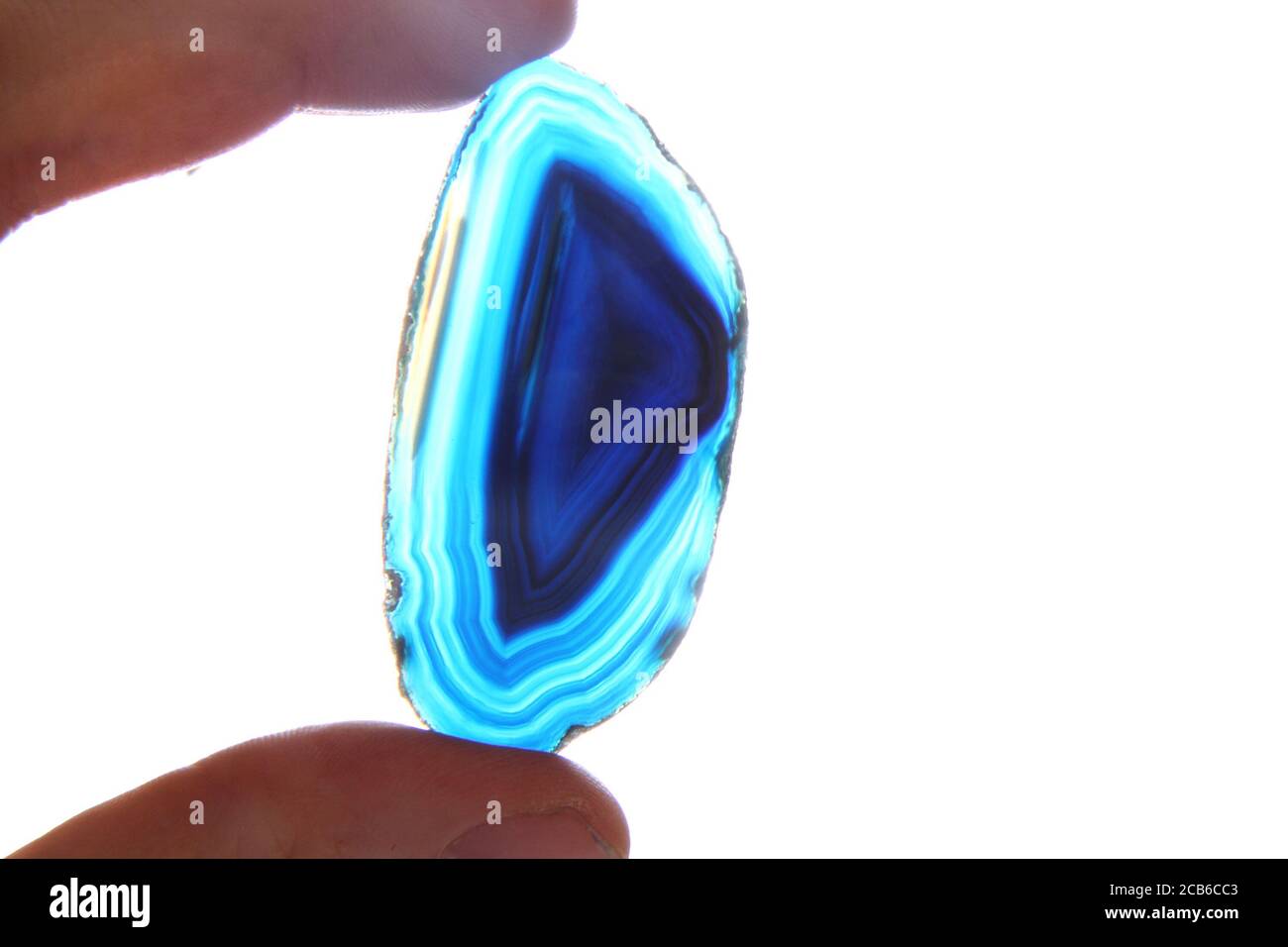 agate gem in human hand isolated on the white background Stock Photo ...