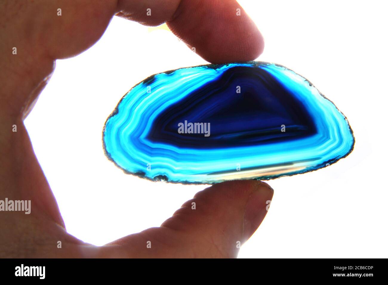 agate gem in human hand isolated on the white background Stock Photo ...