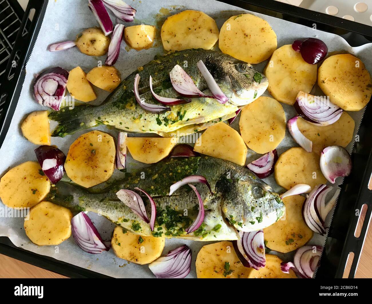 Marinated Two Dorada Fish Sea Bream with Pesto Sauce on Oven Tray with ...