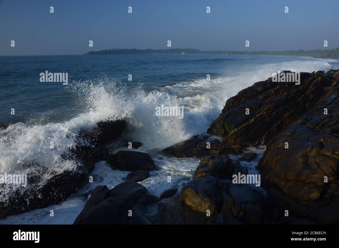 Beautiful scenery of rock formations on the beach with splashing sea ...