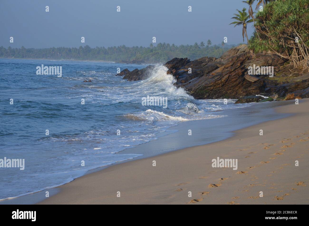 Beautiful scenery of rock formations on the beach with splashing sea ...