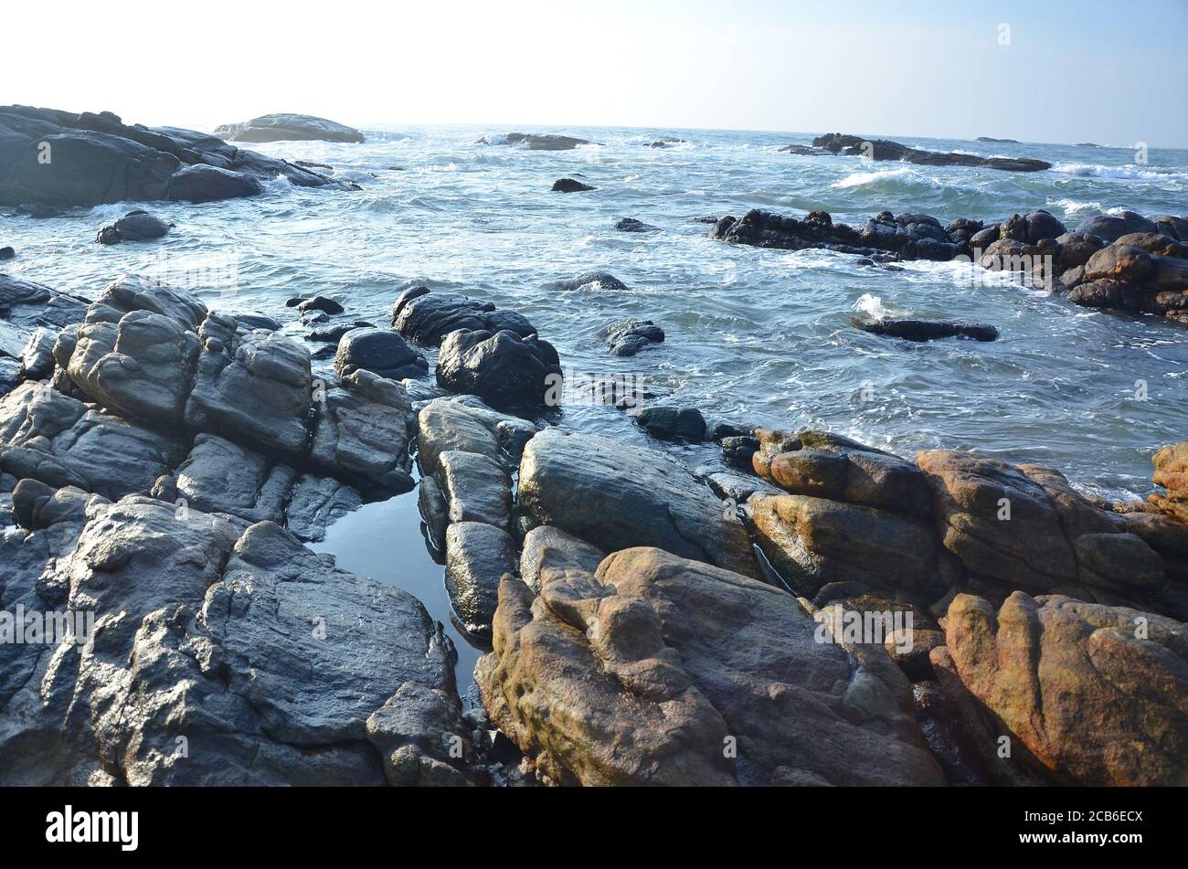 Beautiful scenery of rock formations on the beach with splashing sea ...