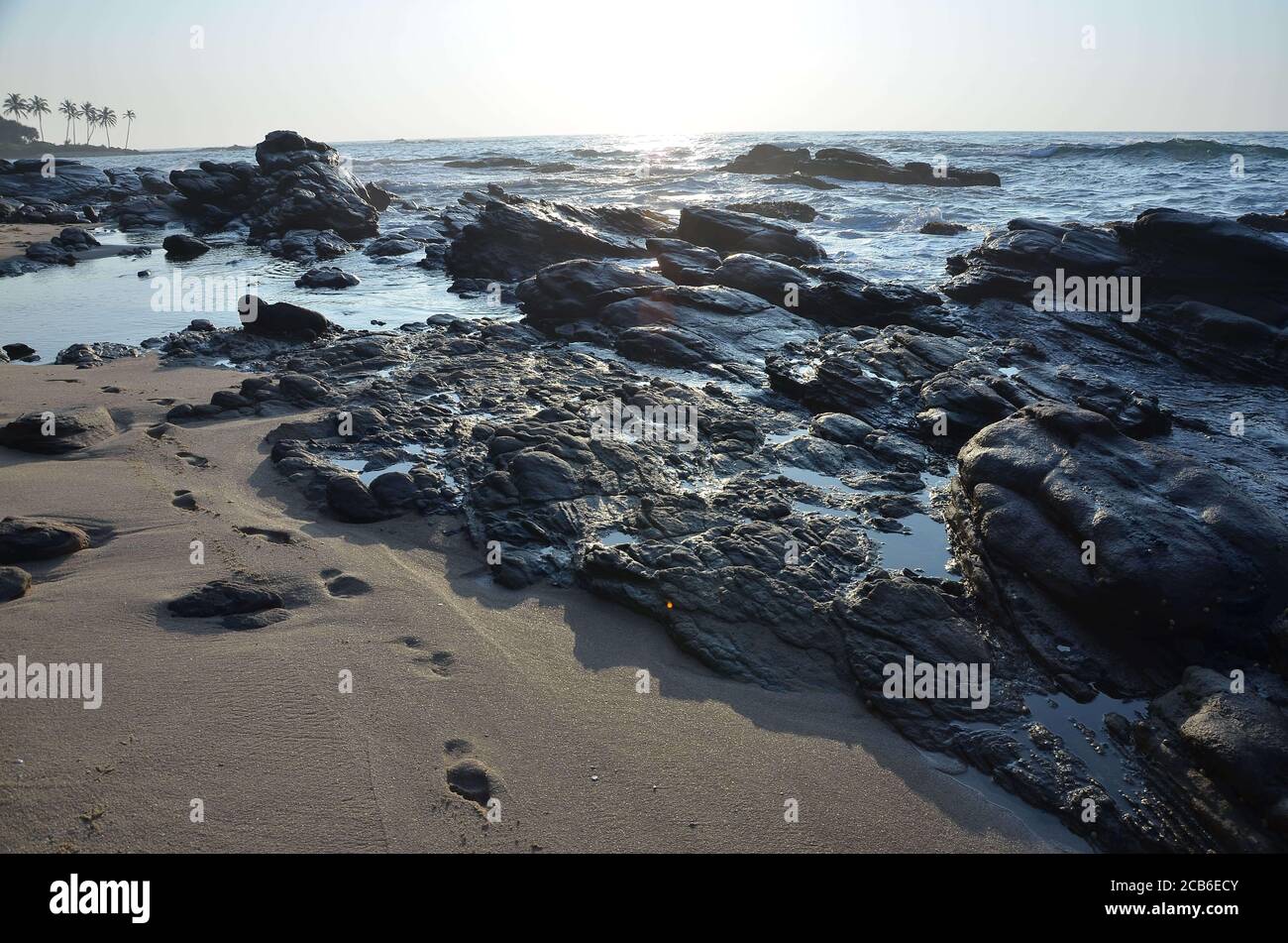Beautiful scenery of rock formations on the beach with splashing sea ...