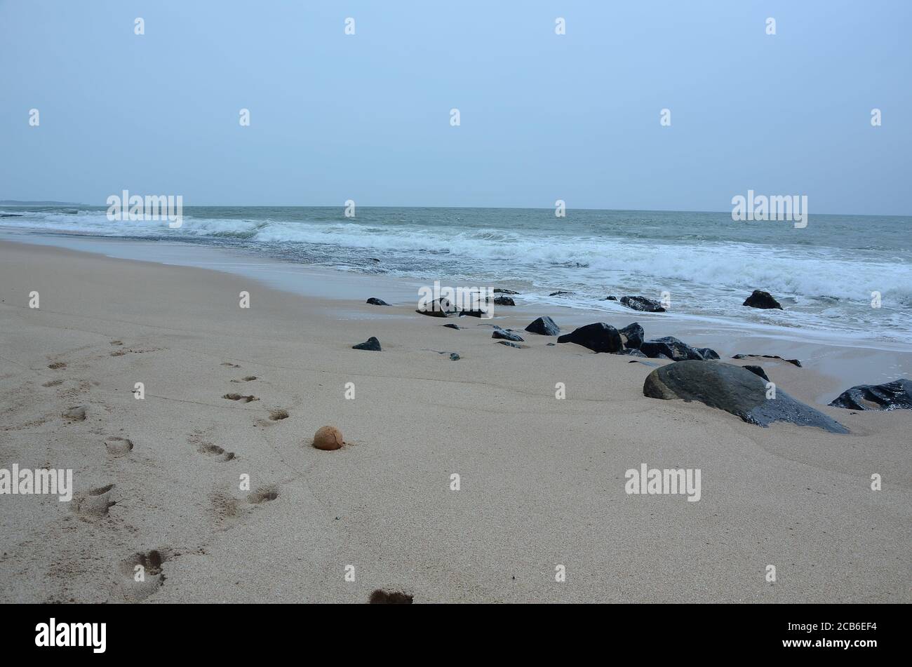 Beautiful scenery of rock formations on the beach with splashing sea ...