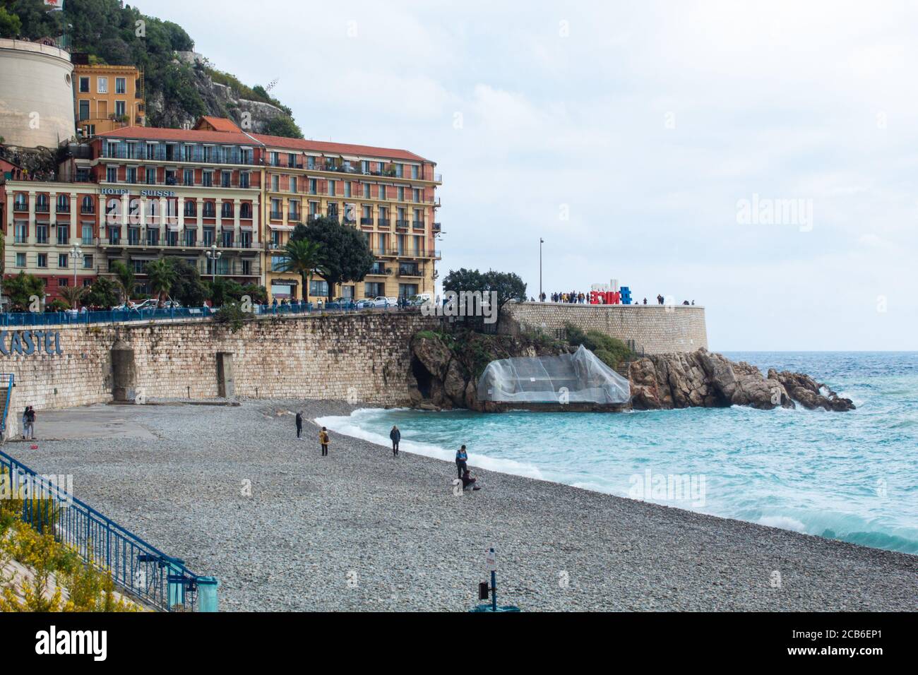 Wavy ocean hitting the sandy beach in Nice, France Stock Photo - Alamy
