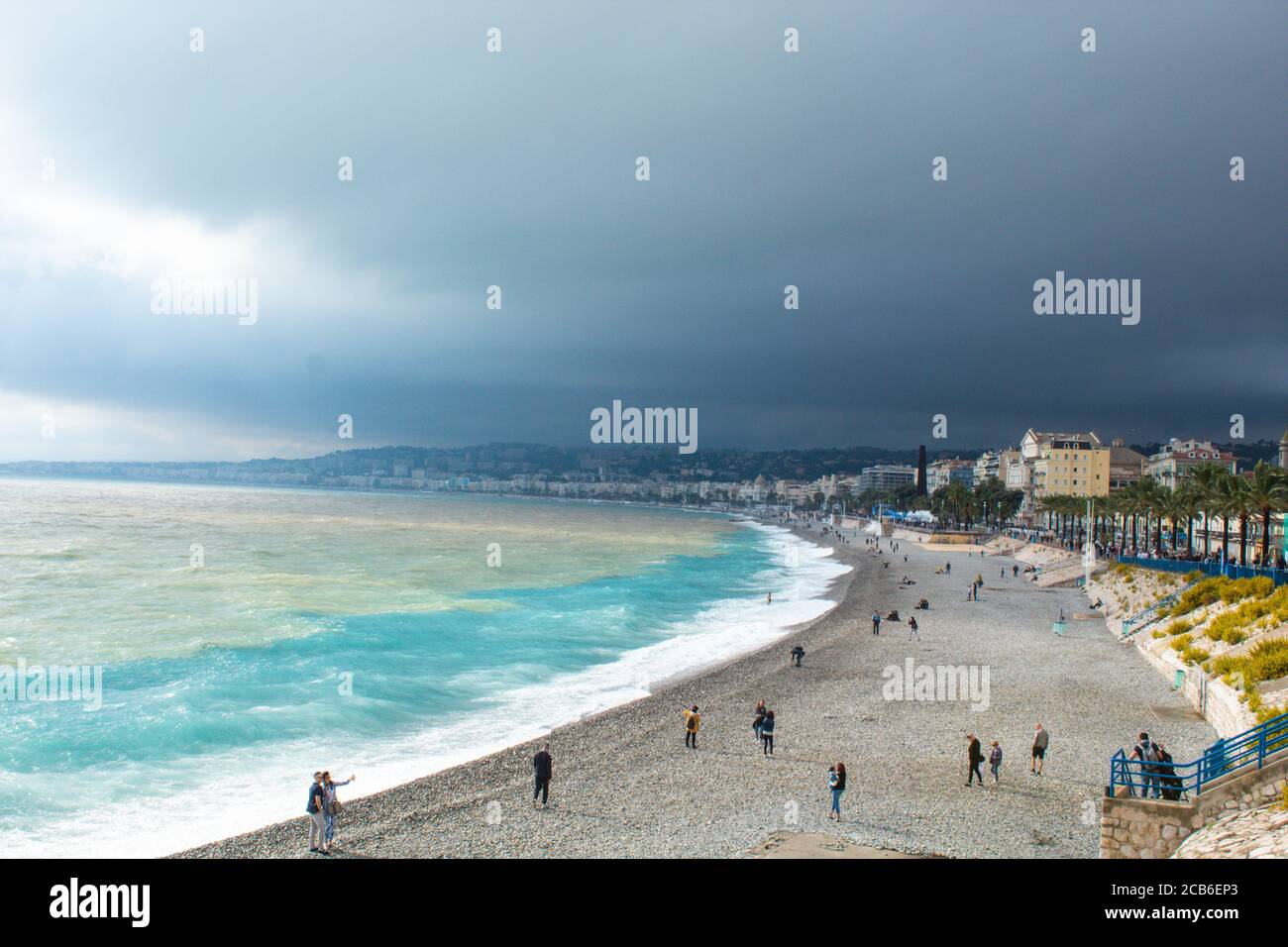 Wavy ocean hitting the sandy beach in Nice, France Stock Photo - Alamy