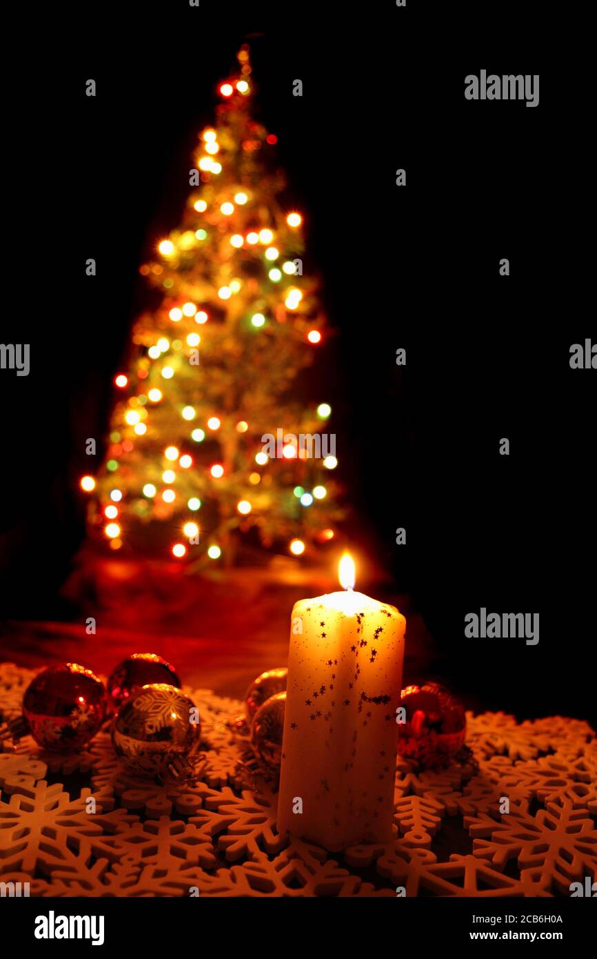 christmas tree and the candle in the night Stock Photo - Alamy