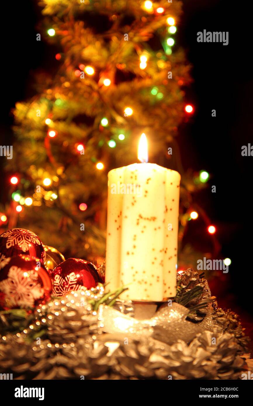 christmas tree and the candle in the night Stock Photo - Alamy