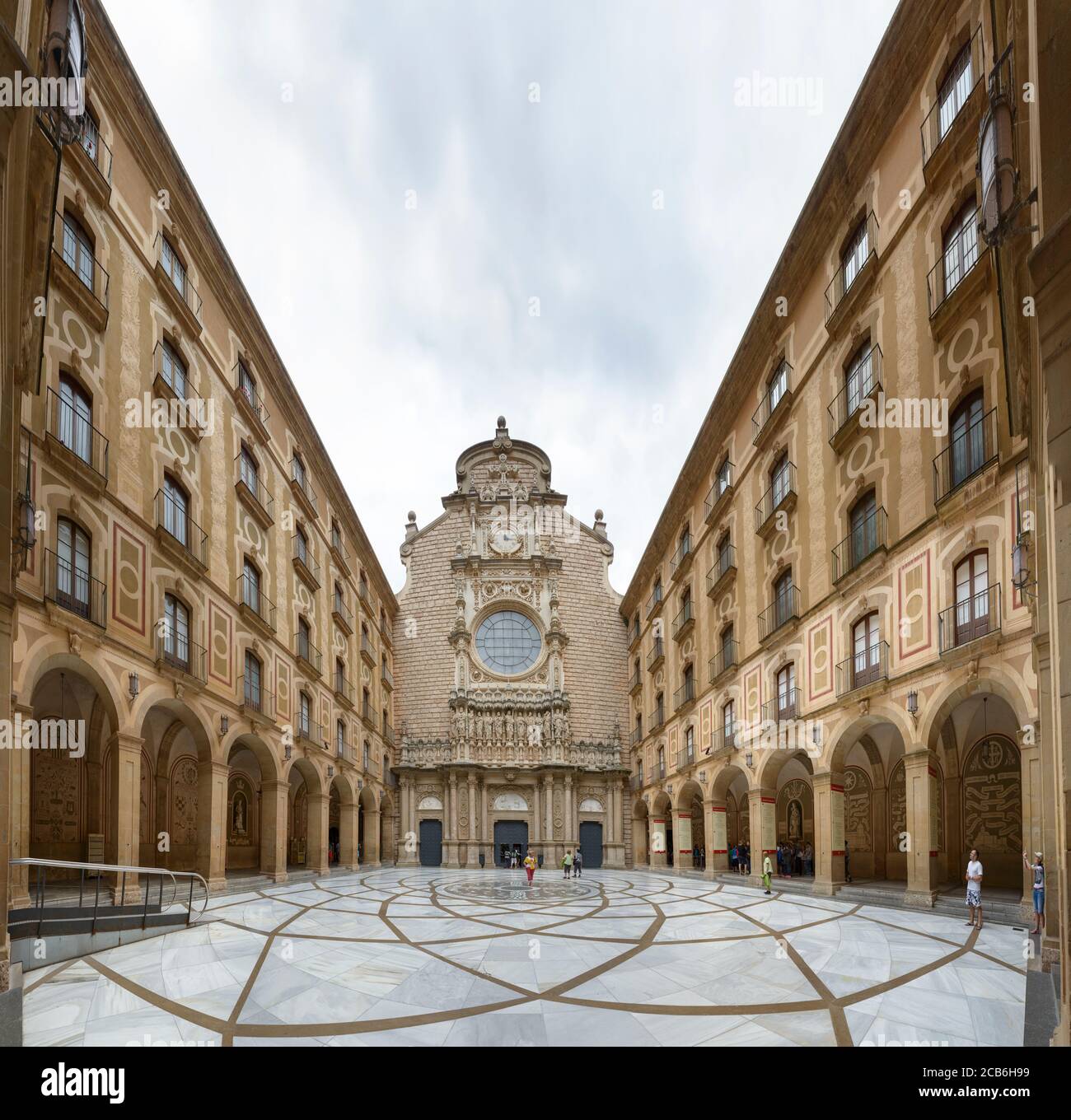 Roofless courtyard in front Basilica of Montserrat abbey facade ...