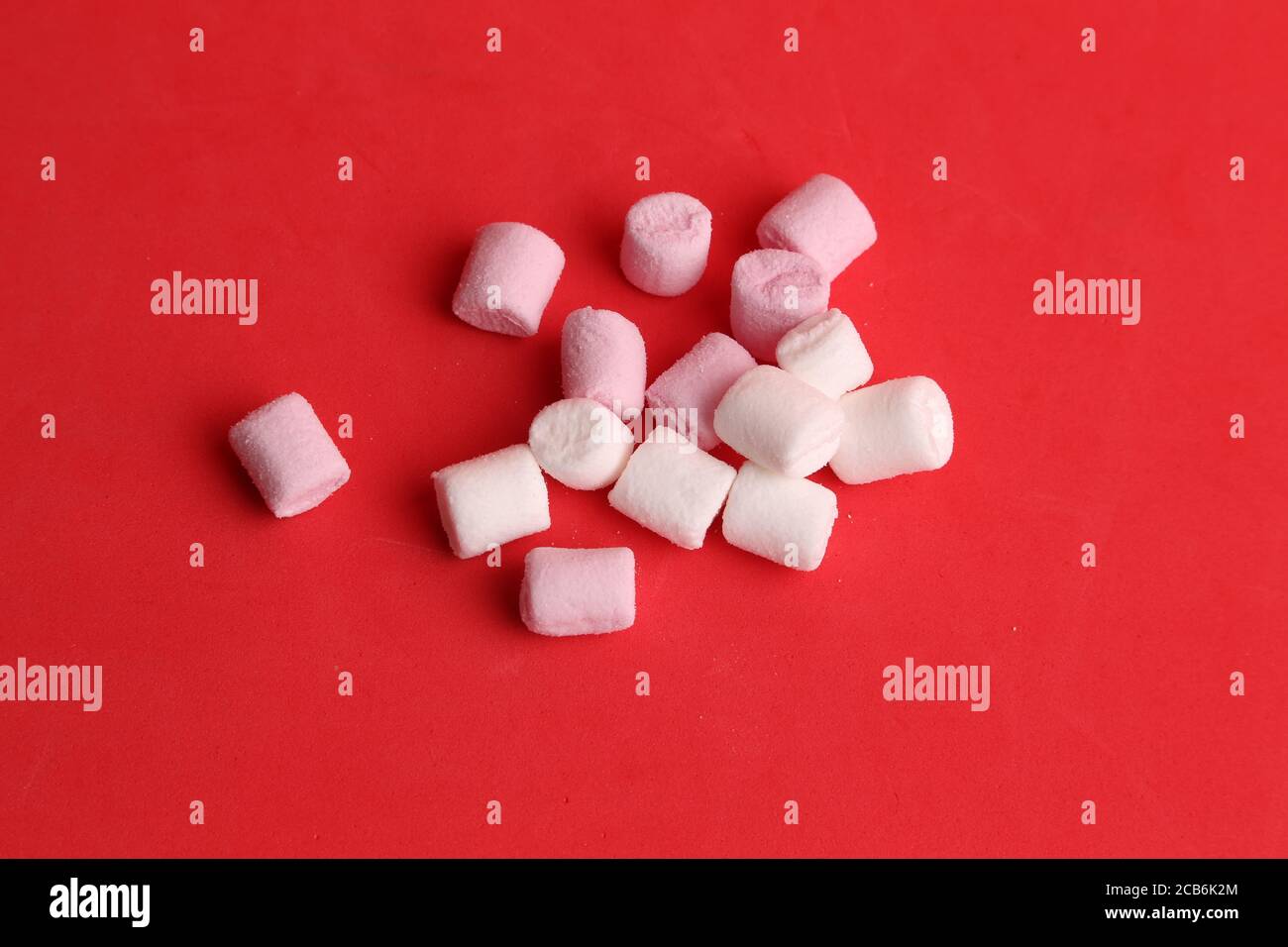 Sweet and delicious marshmallows on the red surface Stock Photo - Alamy