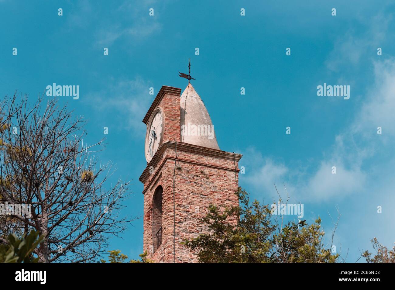 A medieval bell and clock tower of an ancient church (Pesaro, Italy ...
