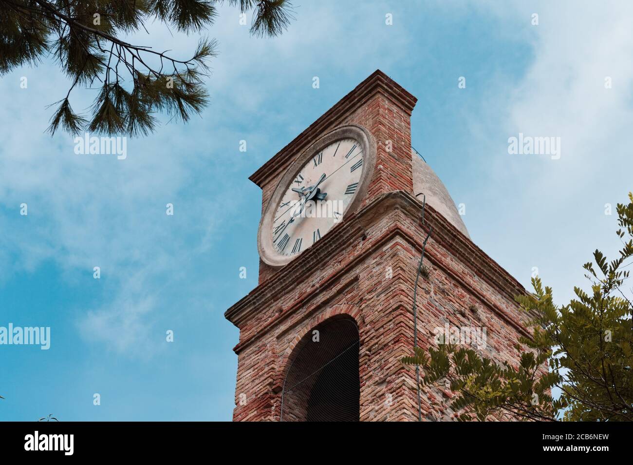 A medieval bell and clock tower of an ancient church (Pesaro, Italy ...