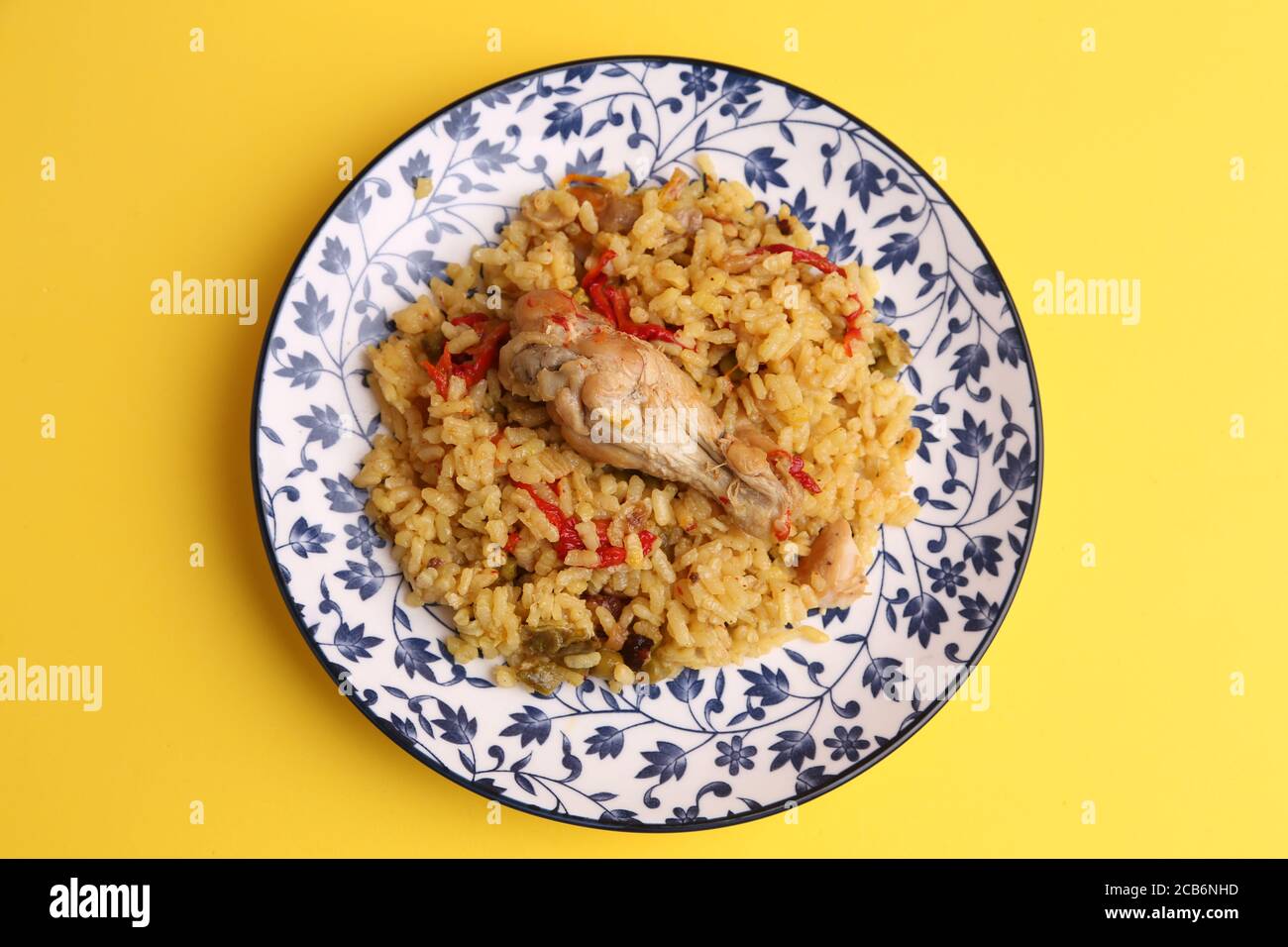 Overhead shot of curry rice and a chicken leg in a decorative plate on ...